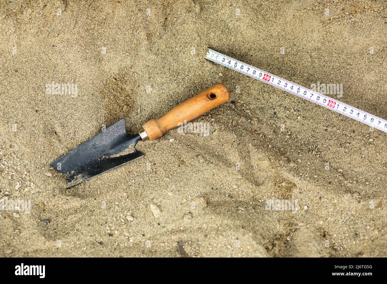 Shovel in the sand.Skeleton and archaeological tools.Digging for ...