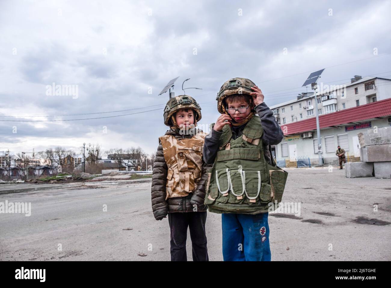Two boy kids wearing military vests and helmet helps out at the ...