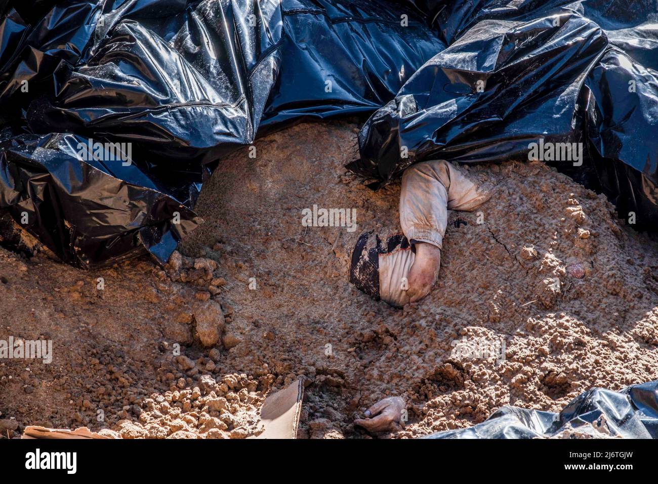 Dead bodies in mass grave hi-res stock photography and images - Alamy