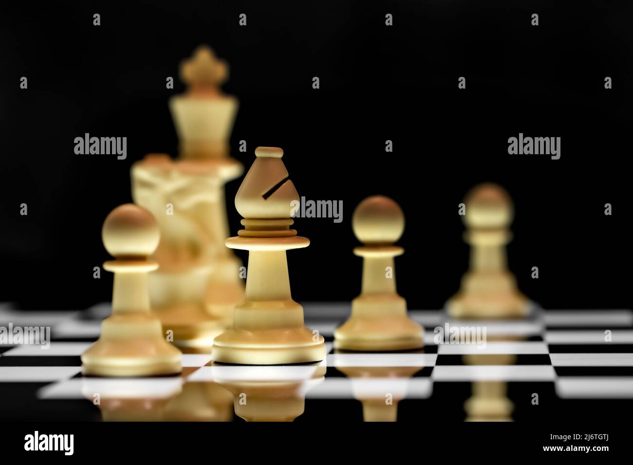 Close up of Chess pieces on a reflective mirror board surface with a ...