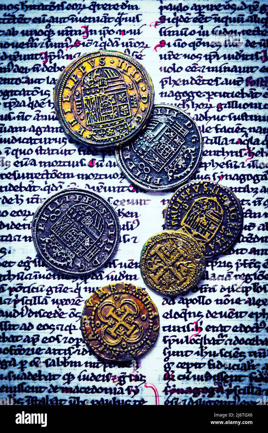 ancient medieval coins over a medieval text Stock Photo - Alamy