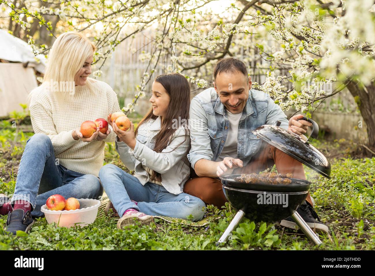 Family having a barbecue in their garden Stock Photo - Alamy