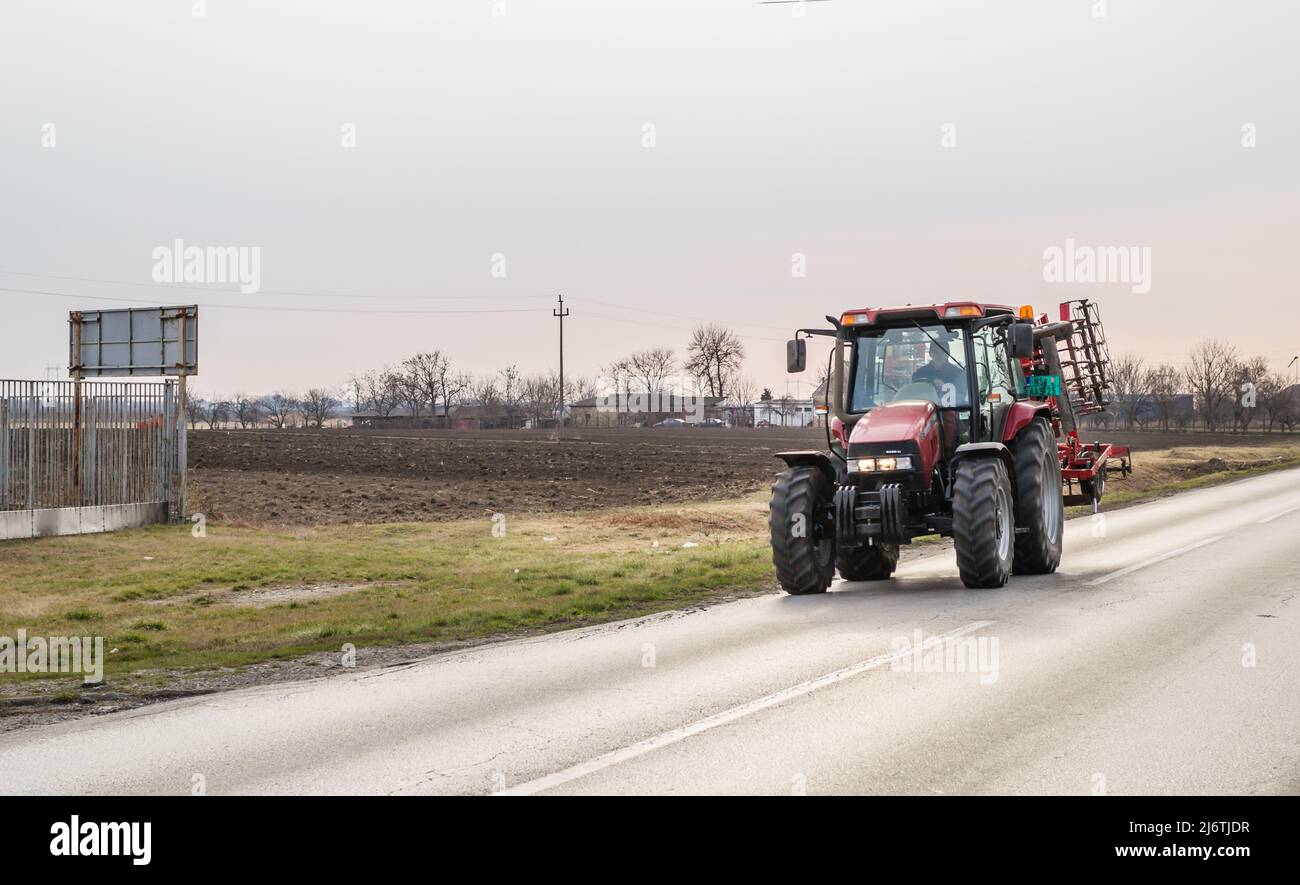 Farmer driving tractor on highway hi-res stock photography and images ...