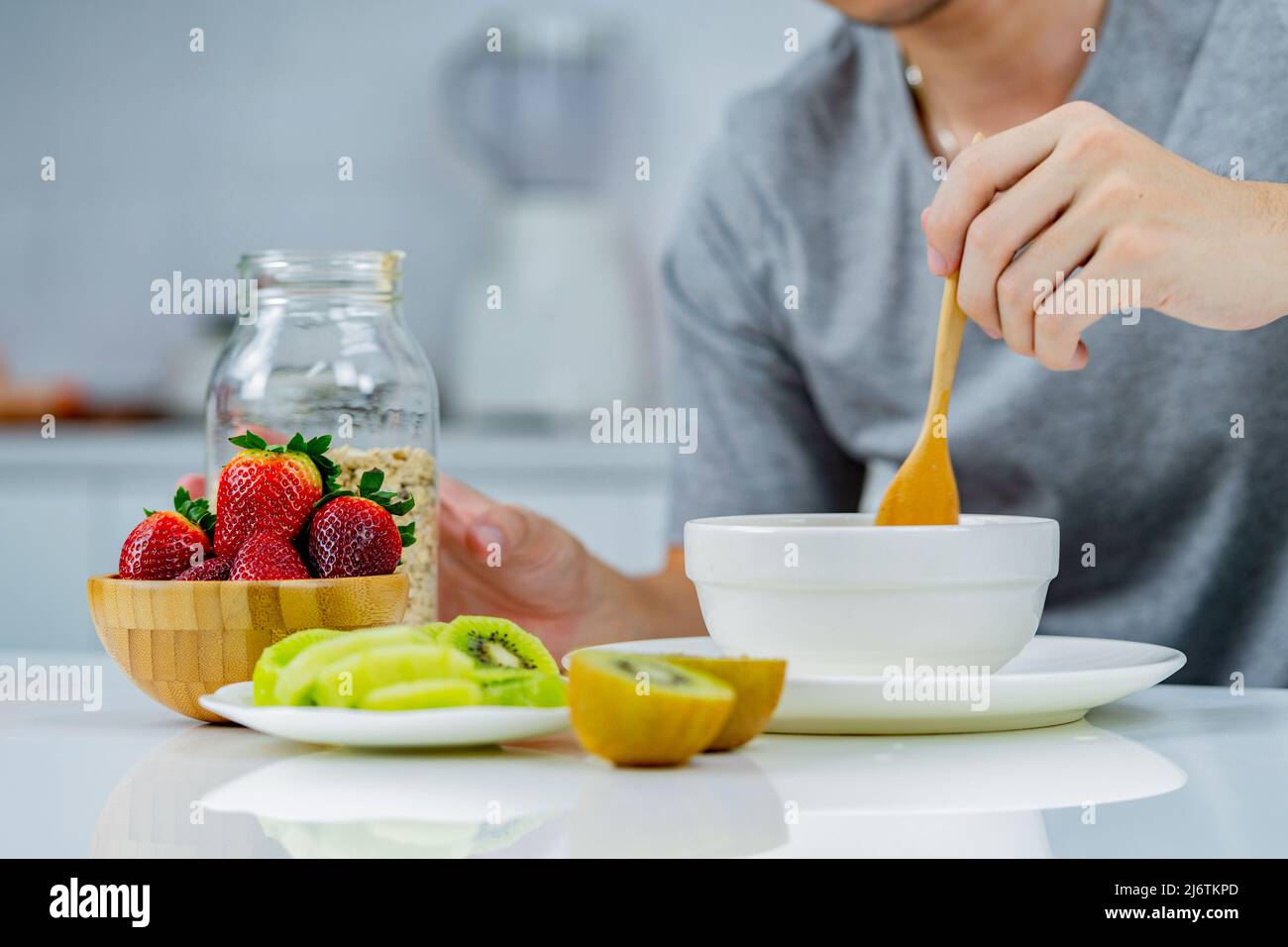 Asian man eating oatmeal for breakfast Stock Photo - Alamy