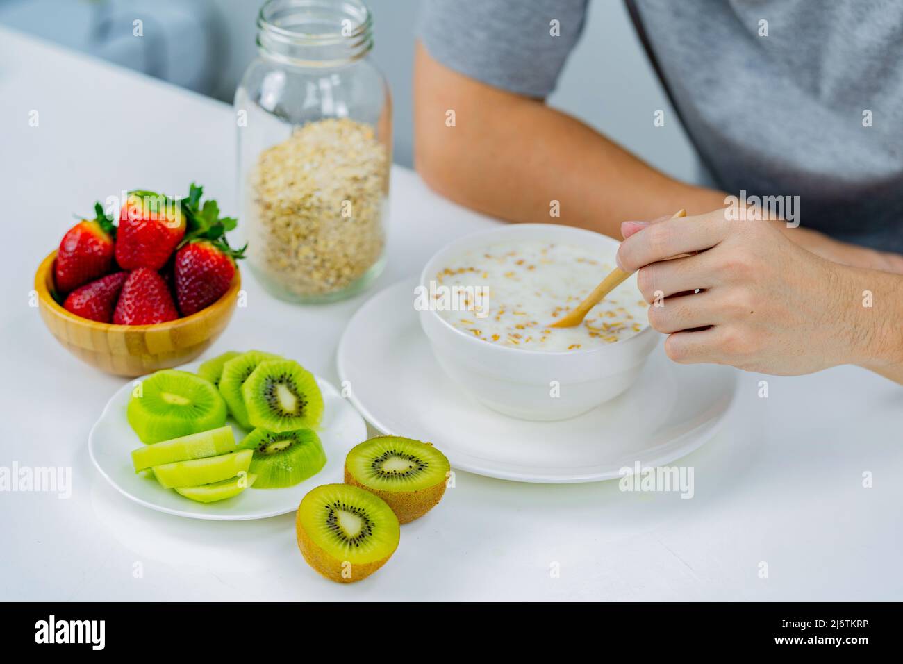 Asian man eating oatmeal for breakfast Stock Photo - Alamy