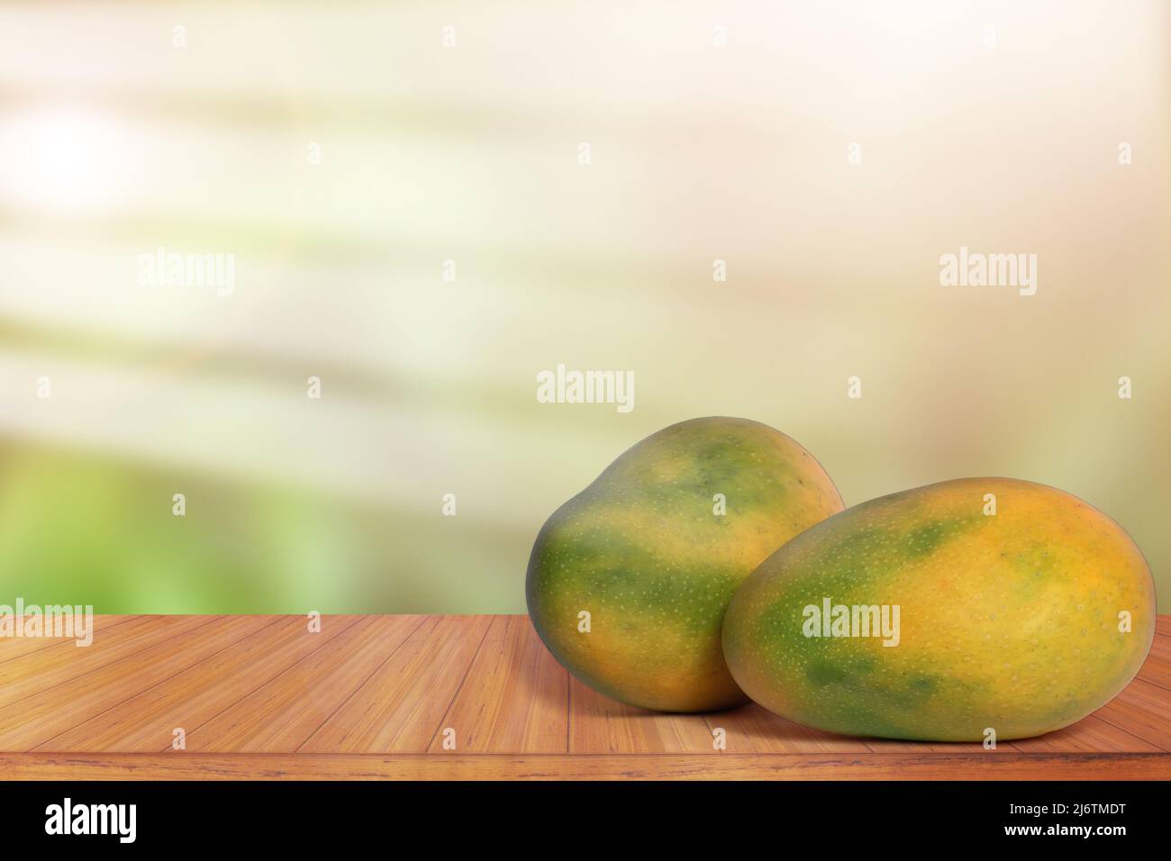 Fresh mango on the table in front of the green garden against the ...