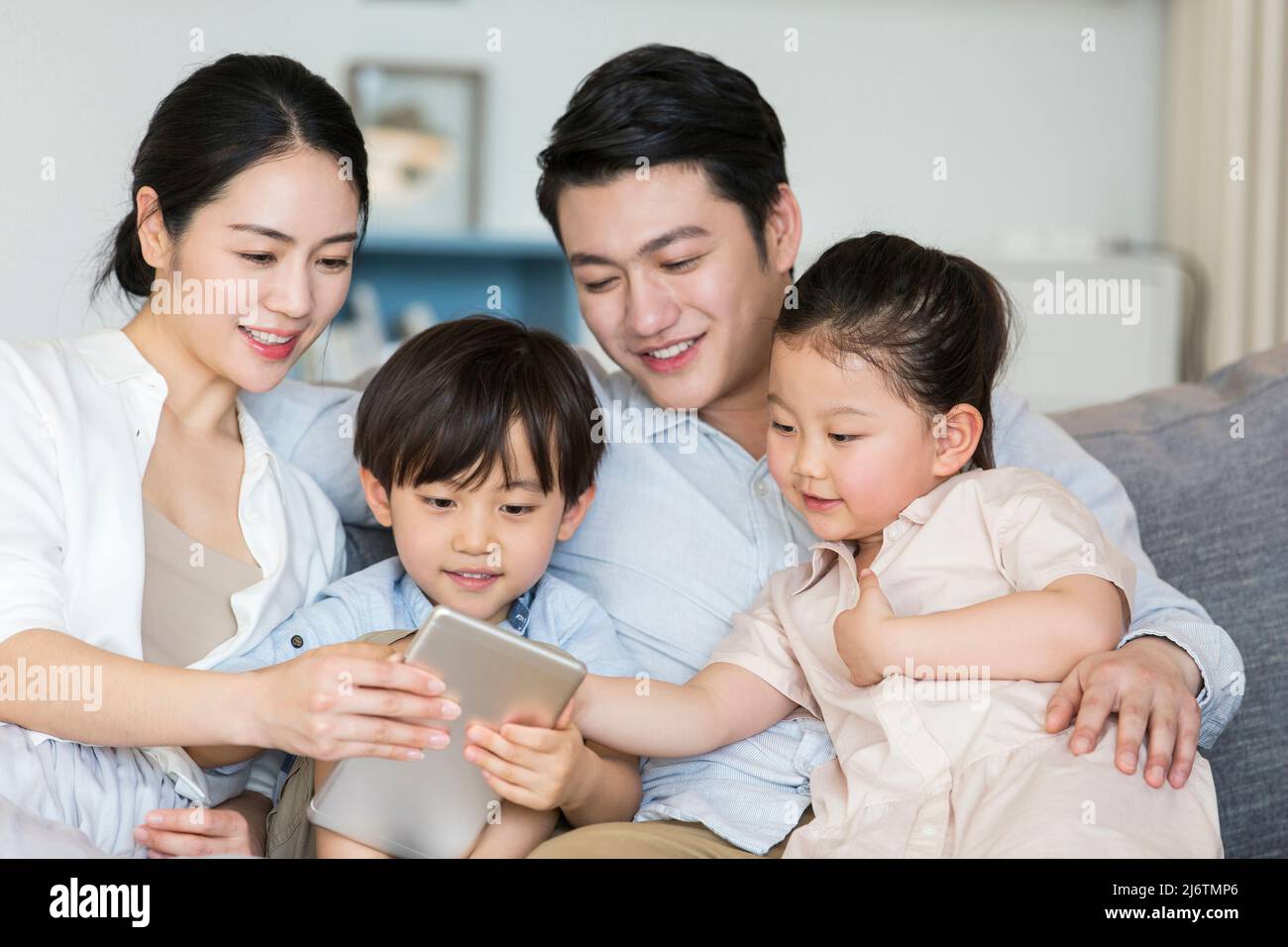 A pair of siblings use a digital tablet to learn preschool curriculum ...