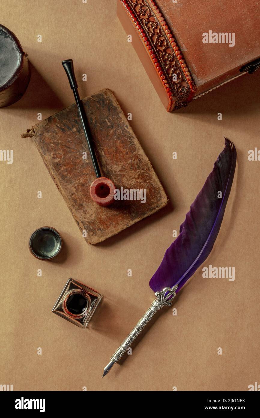Vintage pipe, notebook, a quill pen, and an ink well. Private detective ...