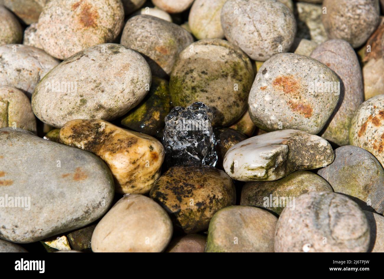 Random stones creating a pebble water feature Stock Photo - Alamy