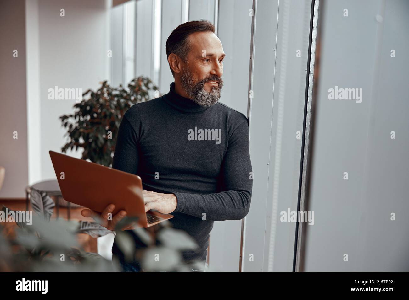 Freelancer man standing window hi-res stock photography and images - Alamy