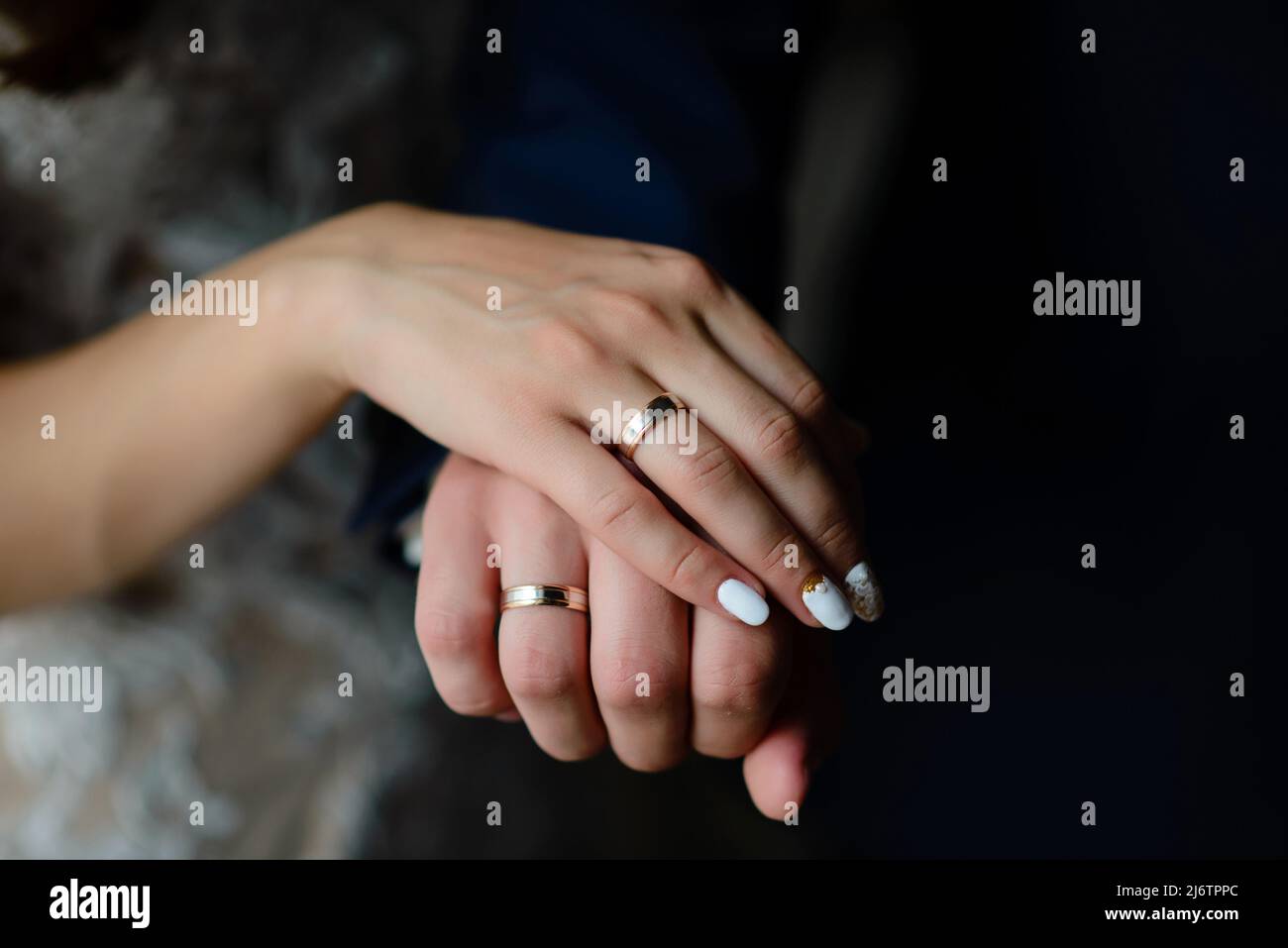 Young married couple holding hands, ceremony wedding day Stock Photo ...