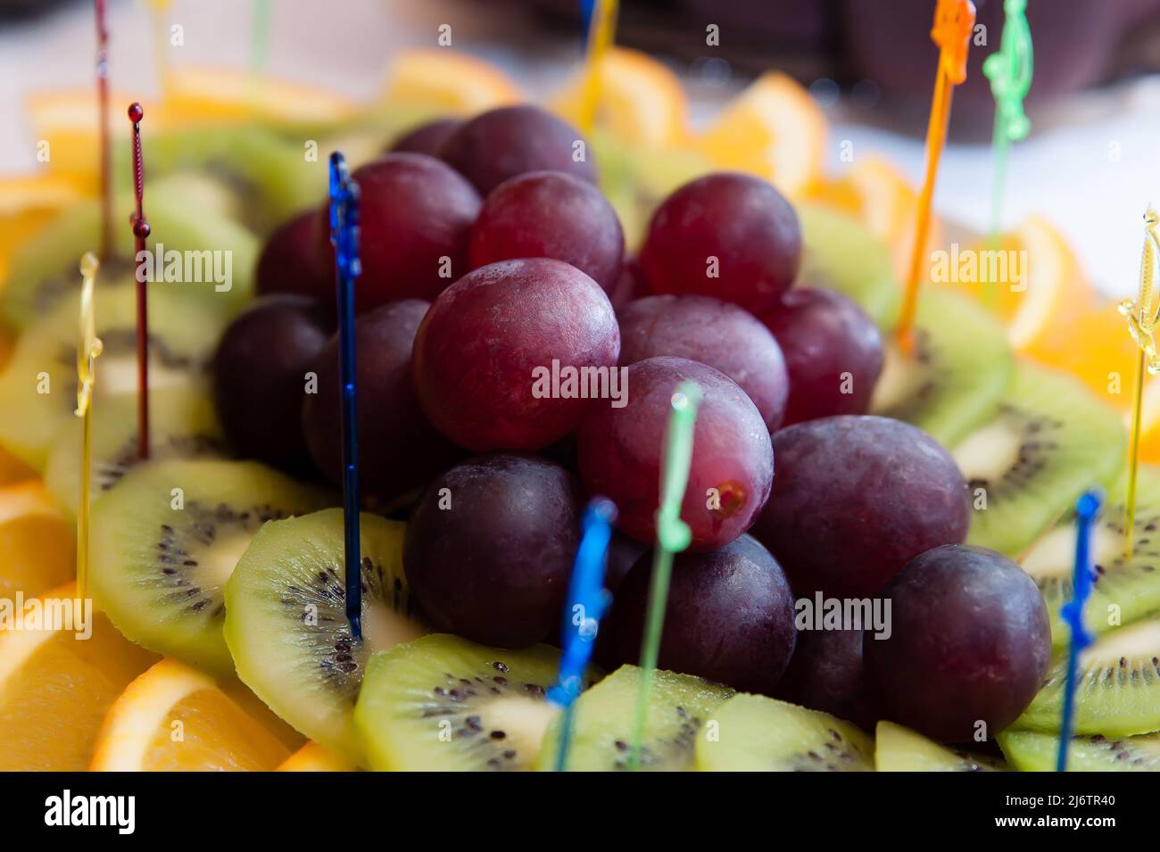 fruit slices on a dish of many different fruits and berries Stock Photo ...