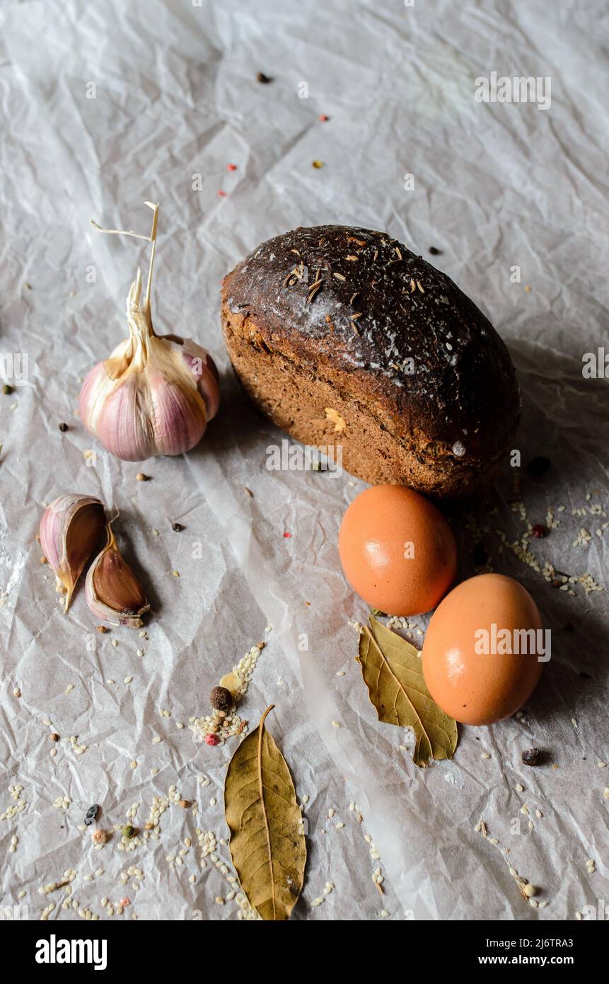 Still life of bread, eggs, garlic and spices Stock Photo - Alamy
