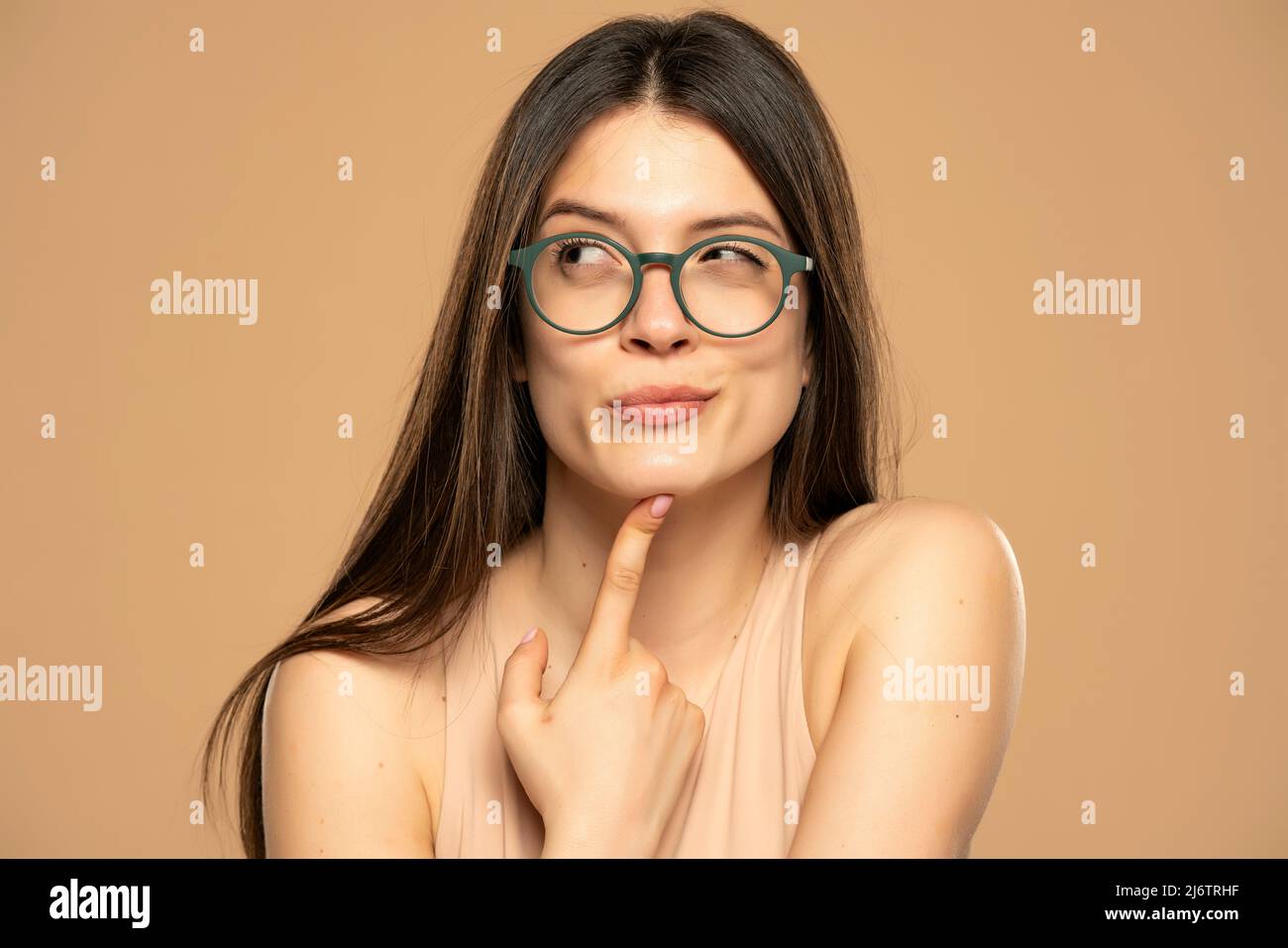 Portrait of young attractive beautiful thoughtful woman with glasses ...