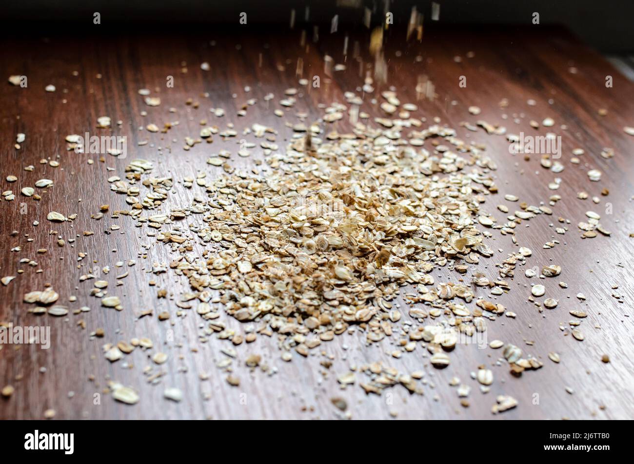 Oat flakes sprinkled on the table Stock Photo - Alamy