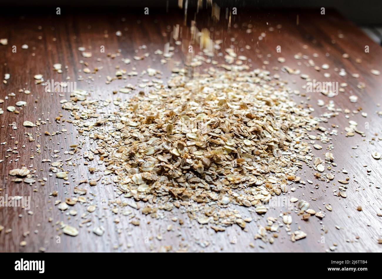 Oat flakes sprinkled on the table Stock Photo - Alamy