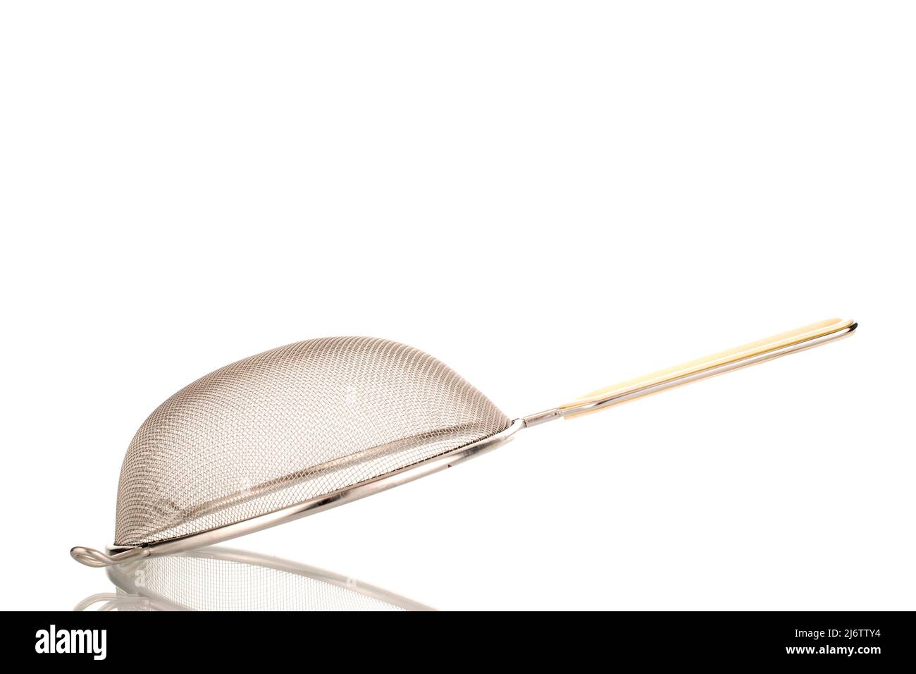 One metal sieve for the kitchen, close-up, isolated on a white ...