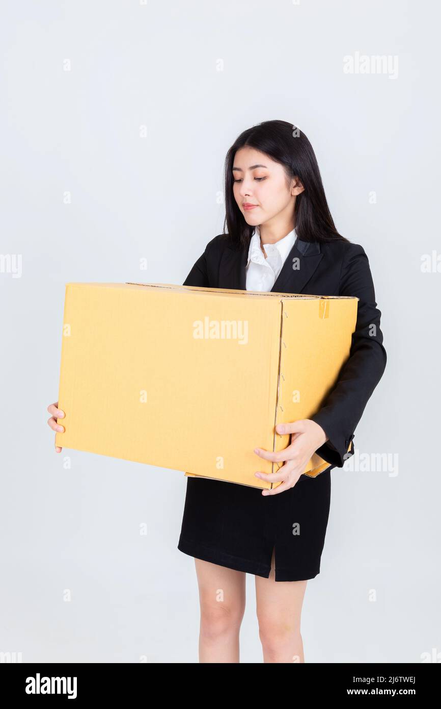Business woman holding brown box, fired from her job Stock Photo - Alamy