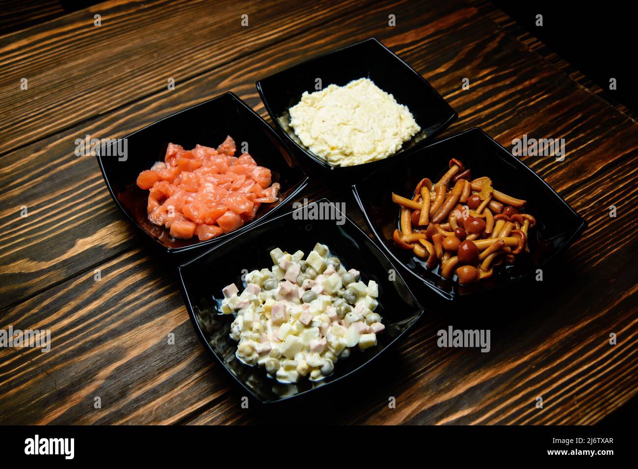 A variety of additives in a salad. From mushrooms, fish and side dishes ...