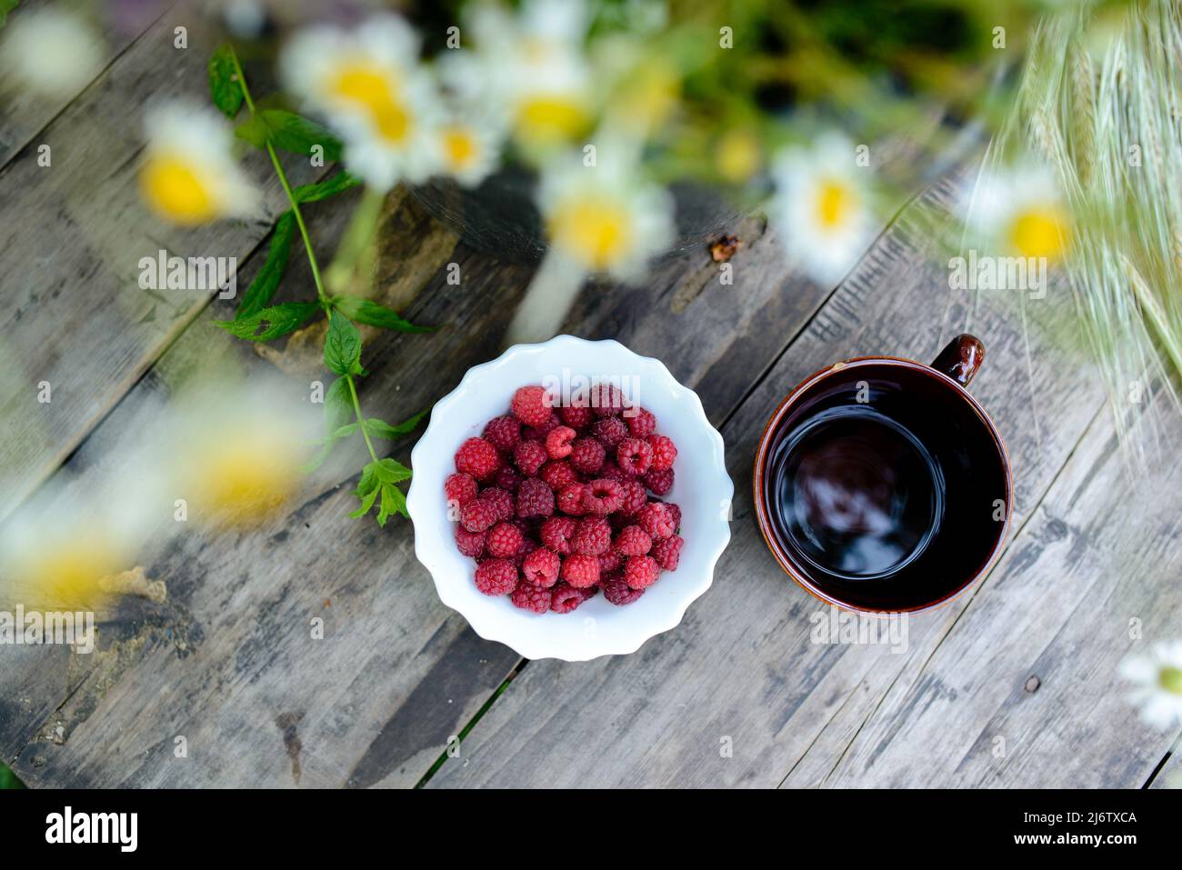 Still life of flowers, raspberries and tea Stock Photo - Alamy