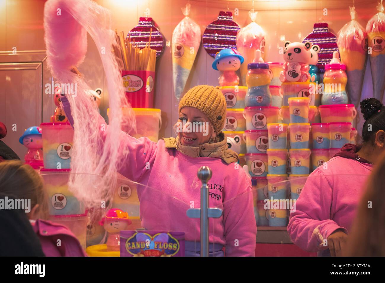 London, UK - December 2, 2021 - A female stuff spinning candy floss at ...