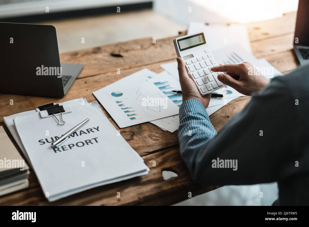 Accountant or bookkeeper working with calculator to calculate business ...