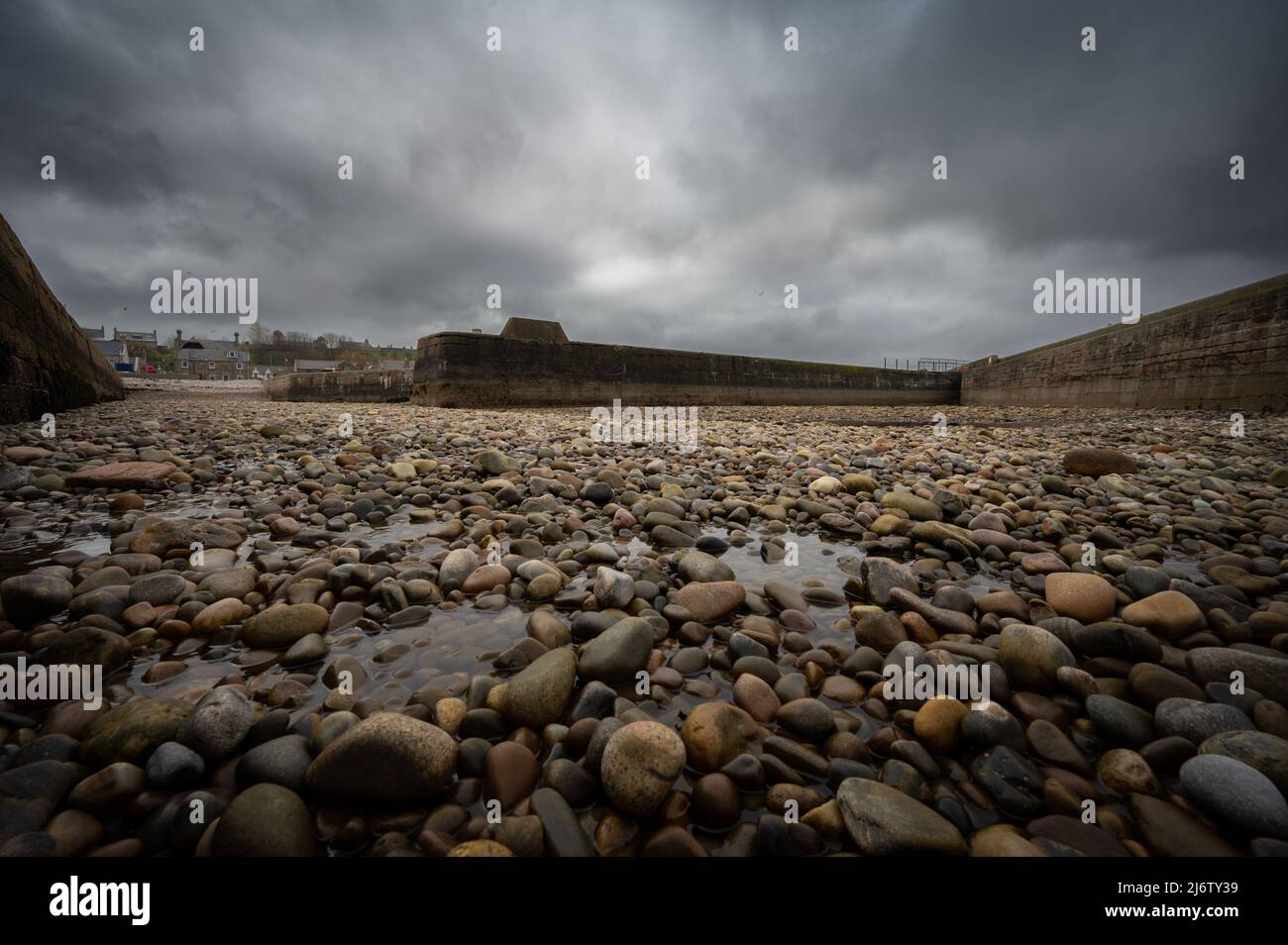 The stone filled harbour at Portgordon near Buckie on the Moray Coast ...