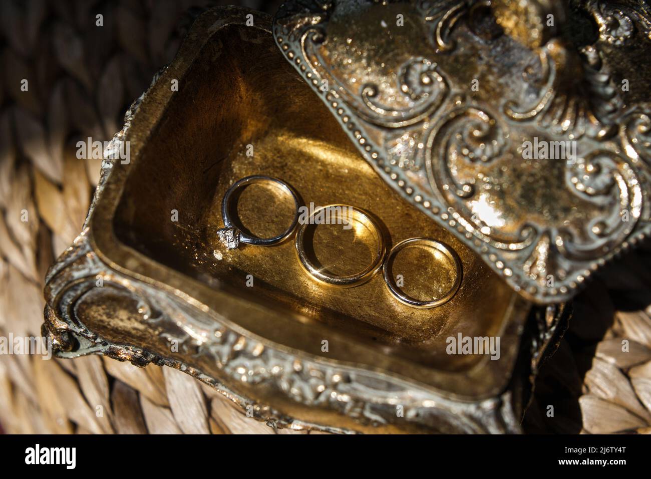 Three wedding rings in a vintage box Stock Photo - Alamy