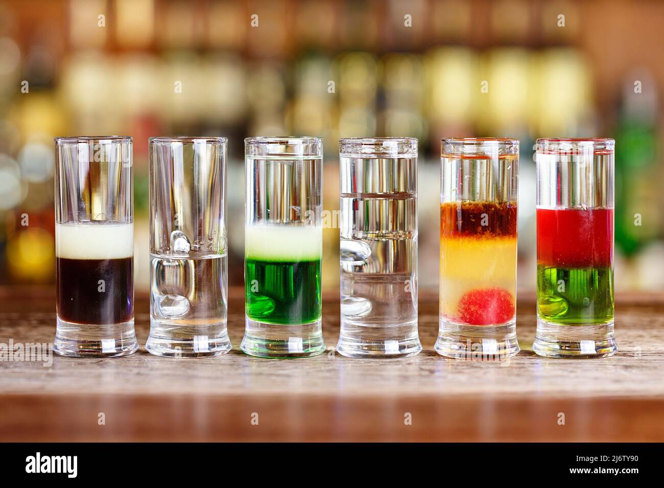 Assortment of cocktails on the bar in a nightclub. Cheerful alcohol ...