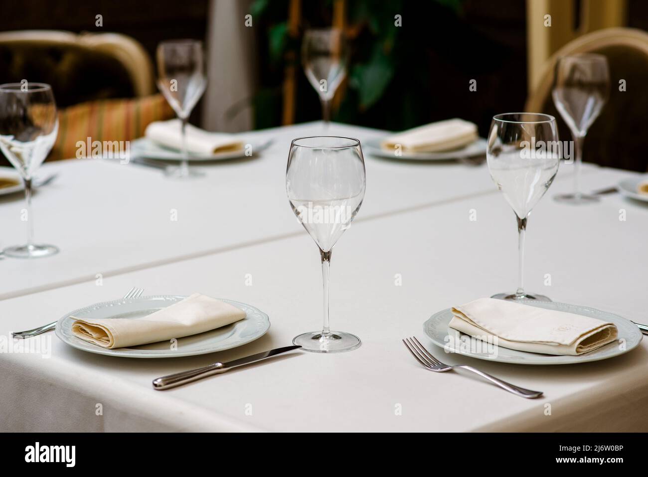 Fancy table set for dinner with flower composition in restaurant ...