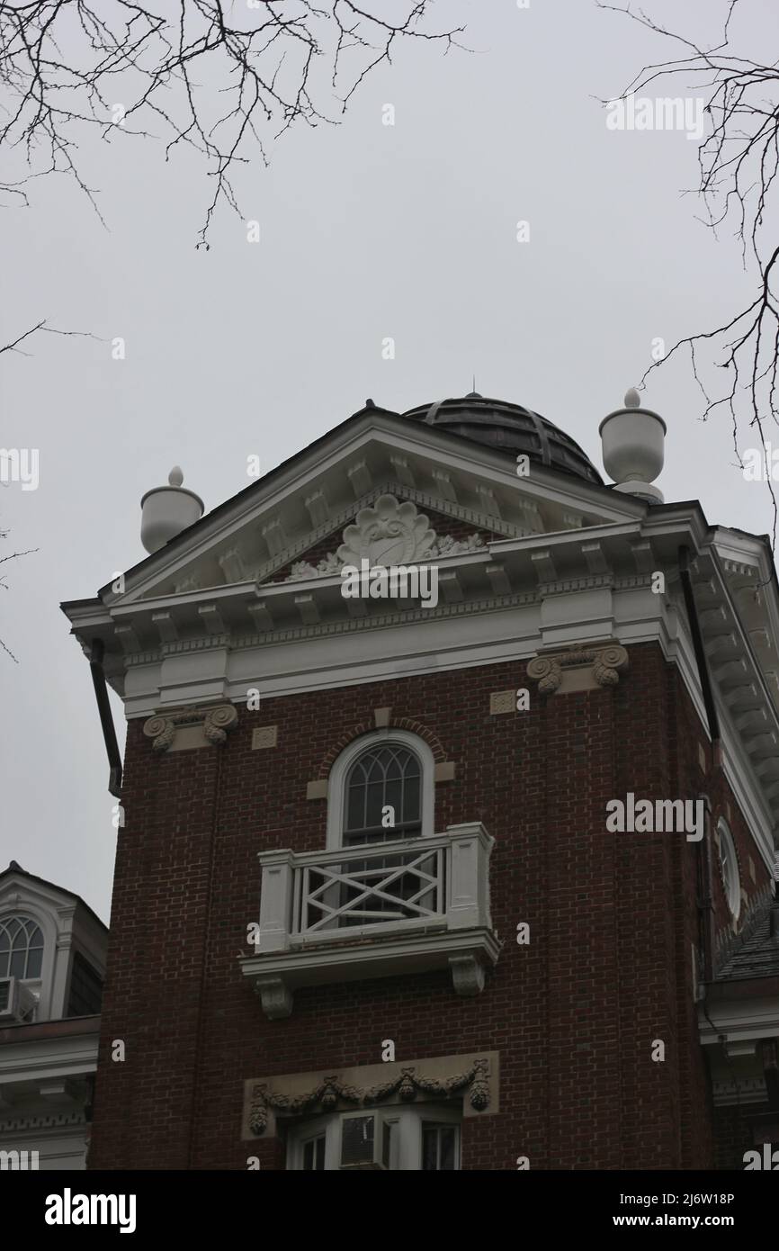 Traditional colonial brick tower with a white window and balcony Stock ...