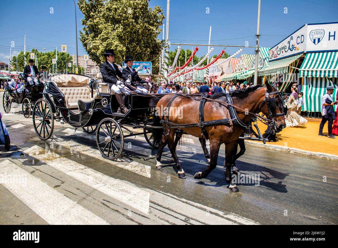 Seville, Spain - May 01, 2022 Sevillians dressed in the traditional ...