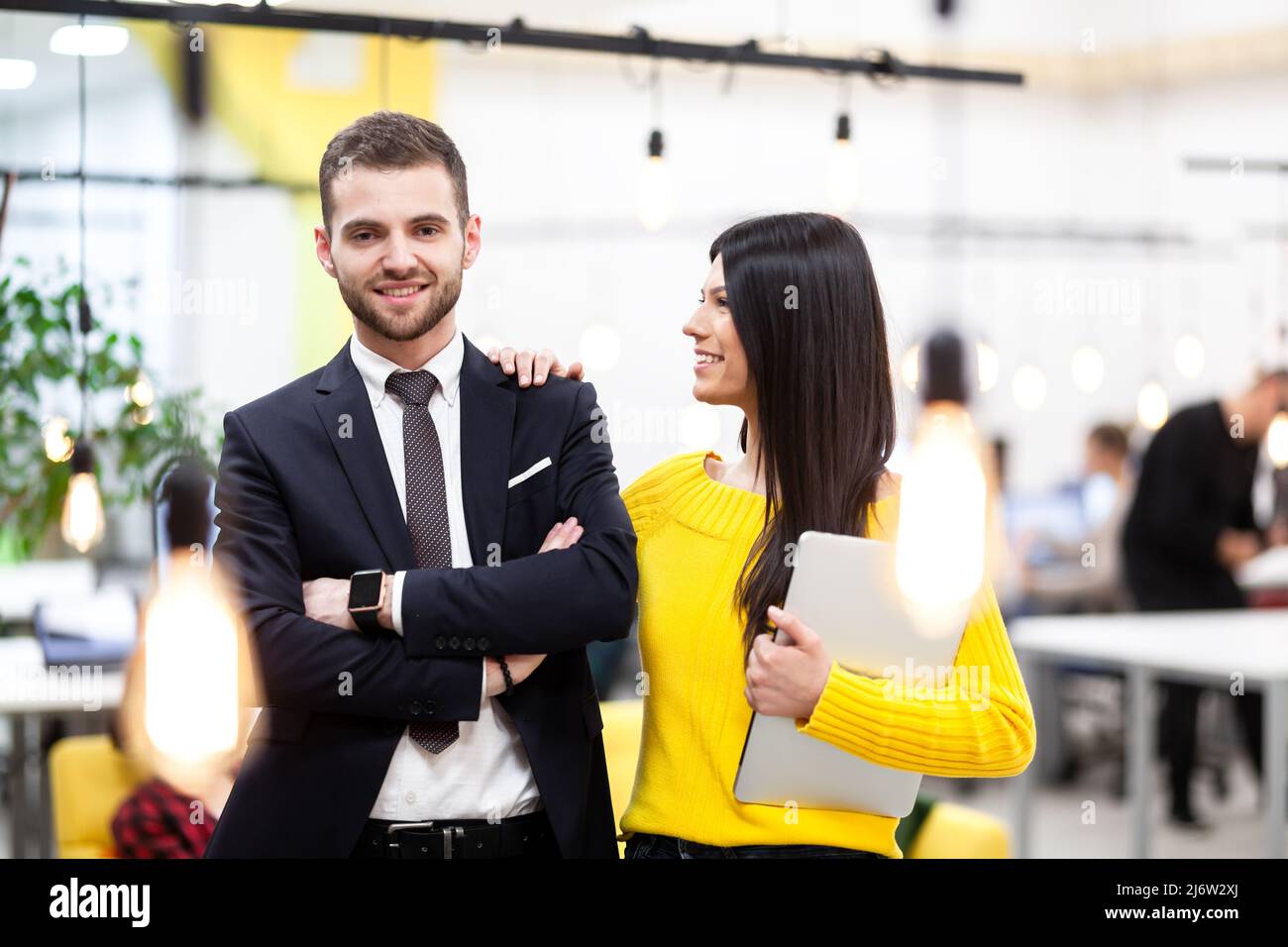 Beautiful Caucasian dark haired girl in yellow posing with businessman ...