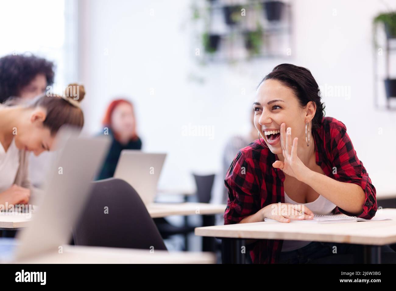 Multi ethnic students listening to a lecturer in a classroom. Smart ...