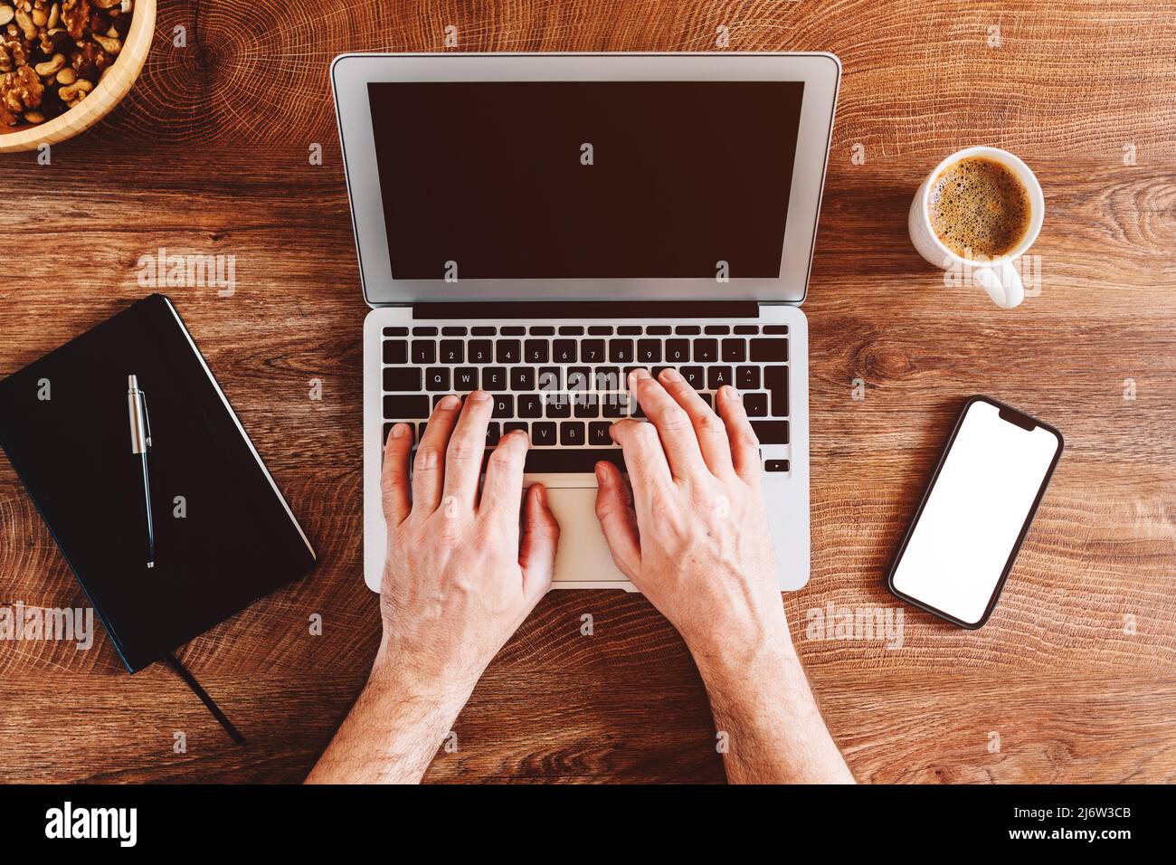 Freelancer working on laptop computer in home office, top view flat lay ...