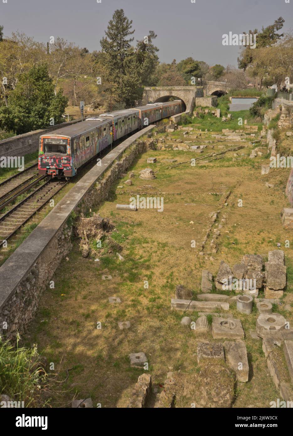 Metro train driving past the old quarter of town near the ...