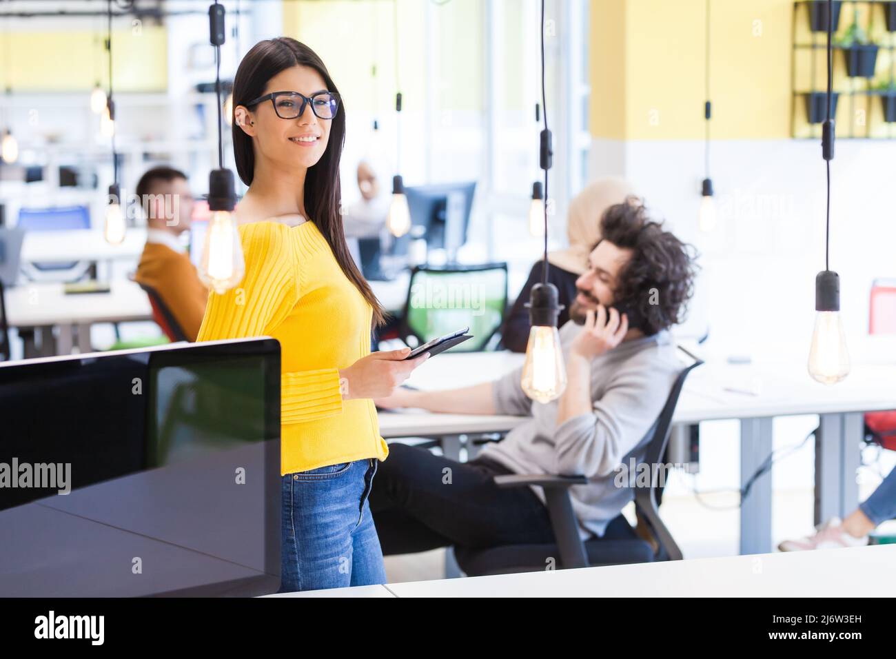 Creative team of young successful people in a modern office. Portrait ...