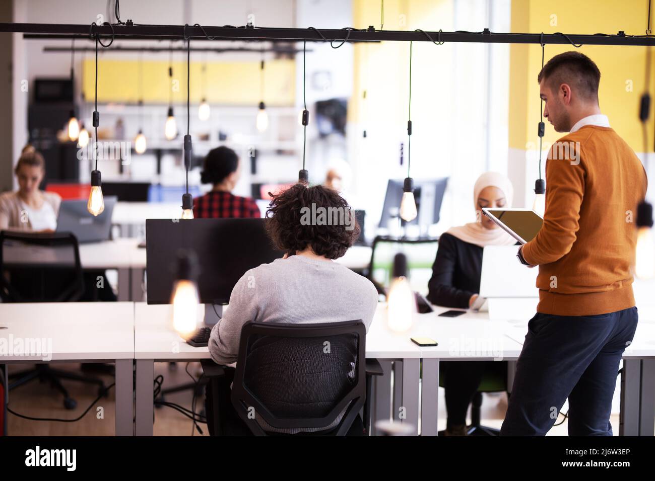 Business people having conversation in front of a computer. Modern ...