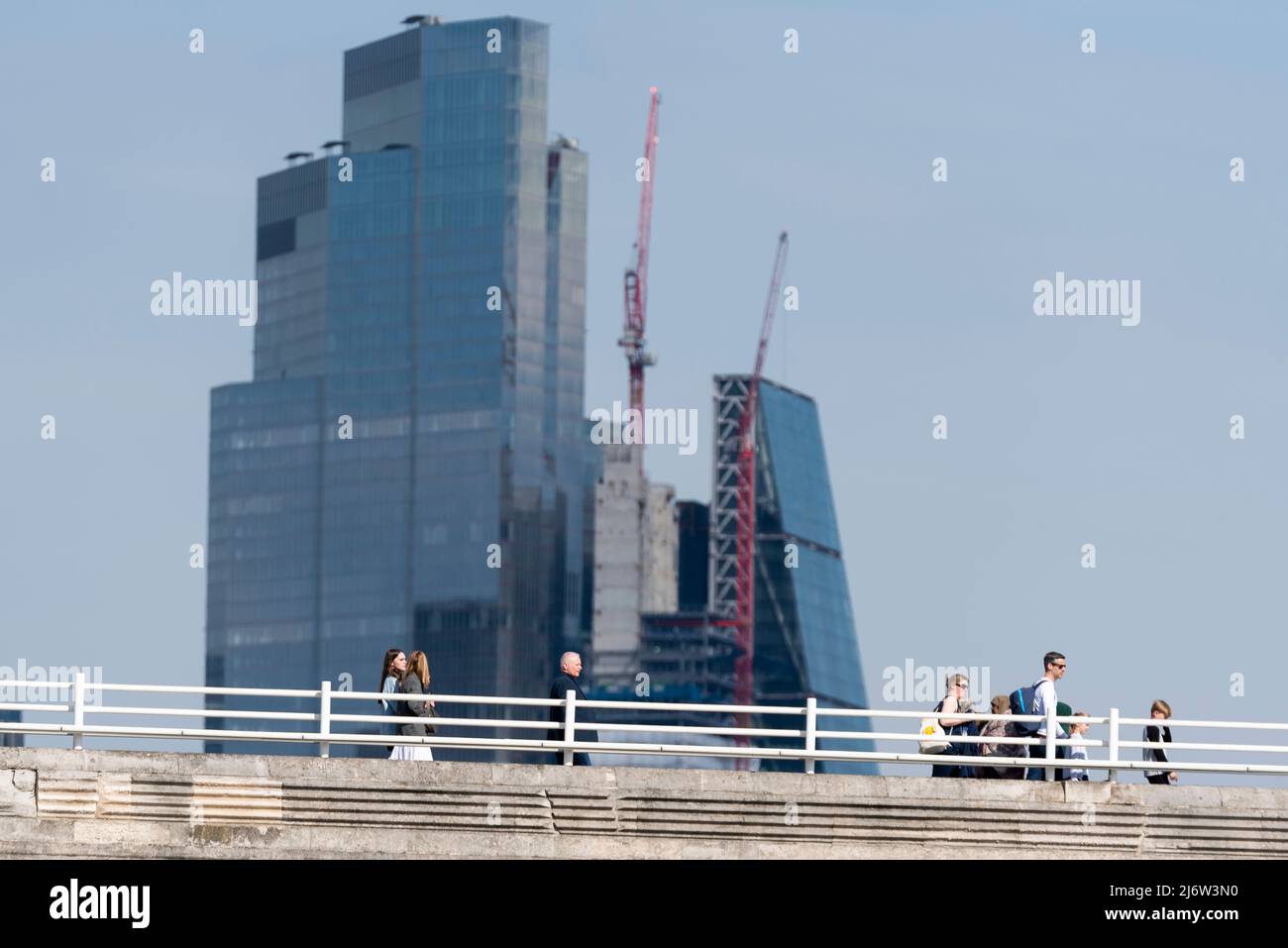 People walking across Waterloo Bridge in London, with skyscraper ...