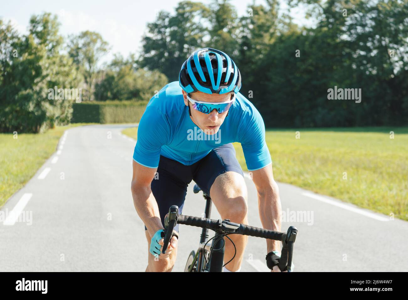Muscular man, professional racing bicyclist sprint cycling, with ...