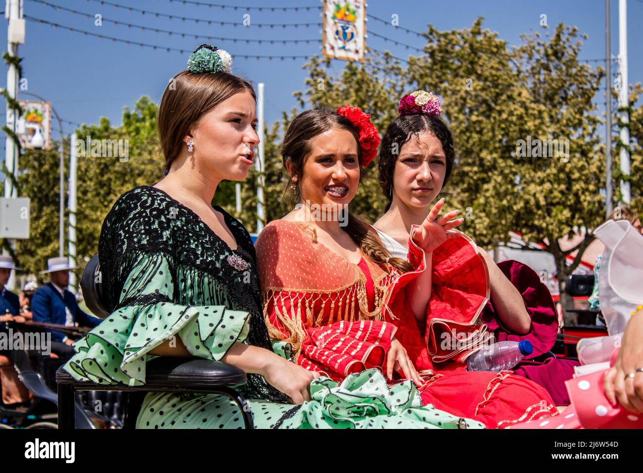 Seville, Spain - May 01, 2022 Sevillians dressed in the traditional ...