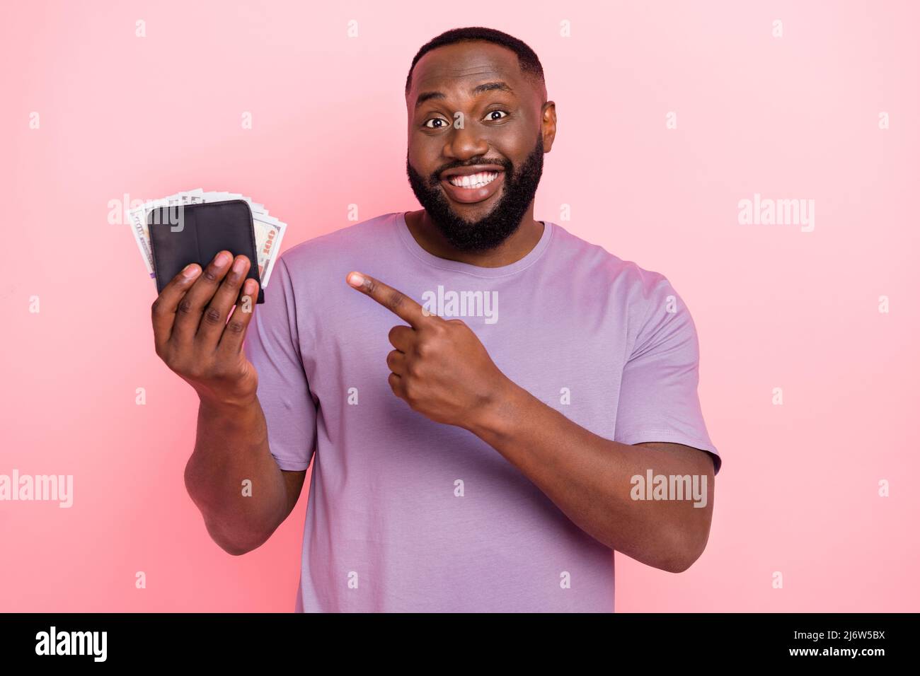 Photo of sweet charming guy dressed violet t-shirt biting pointing ...