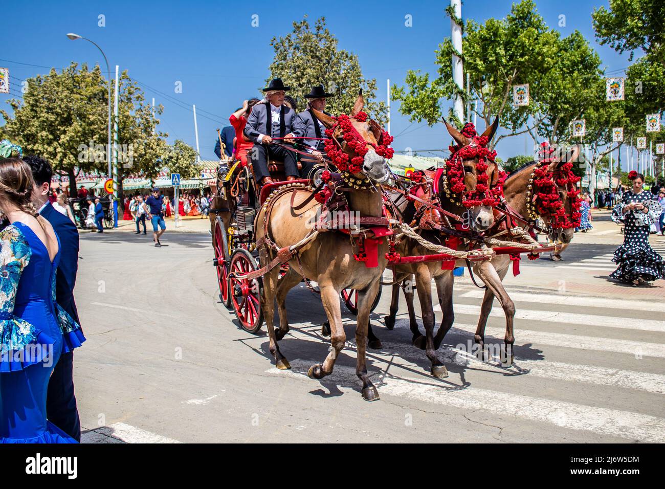 Seville, Spain - May 01, 2022 Sevillians dressed in the traditional ...