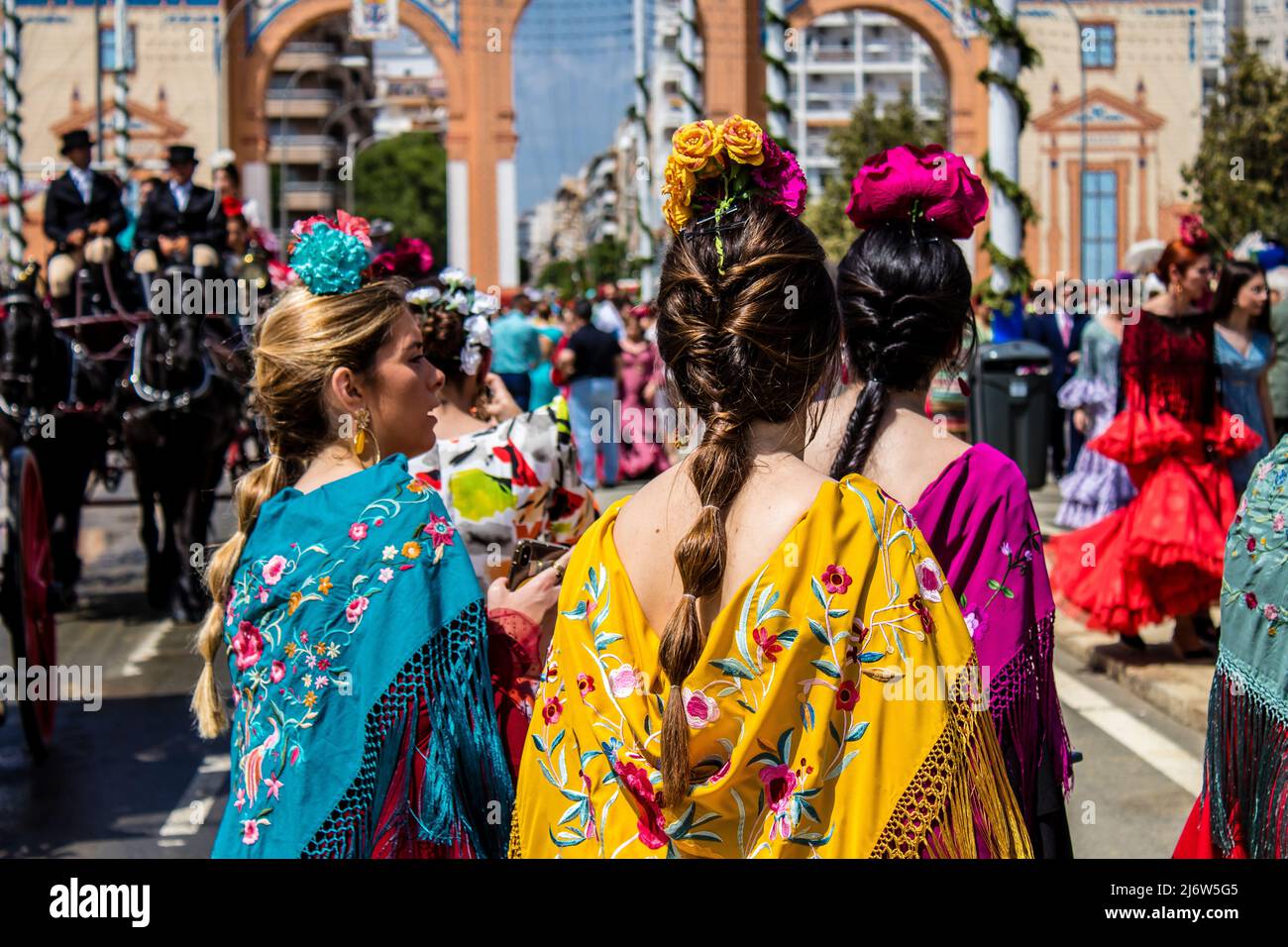 Seville, Spain - May 01, 2022 Sevillians dressed in the traditional ...