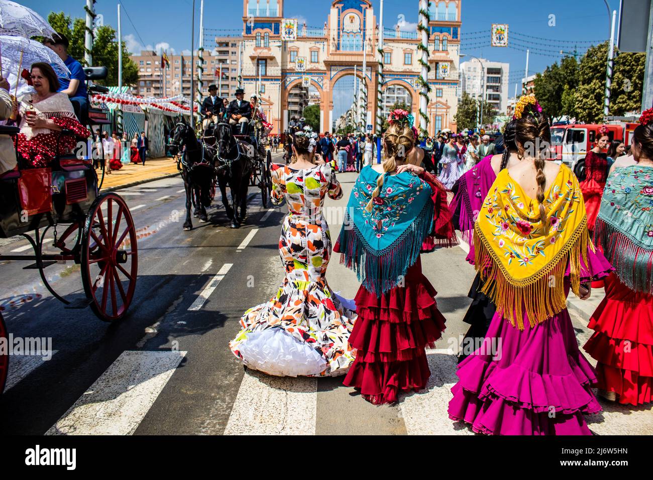 Seville, Spain - May 01, 2022 Sevillians dressed in the traditional ...