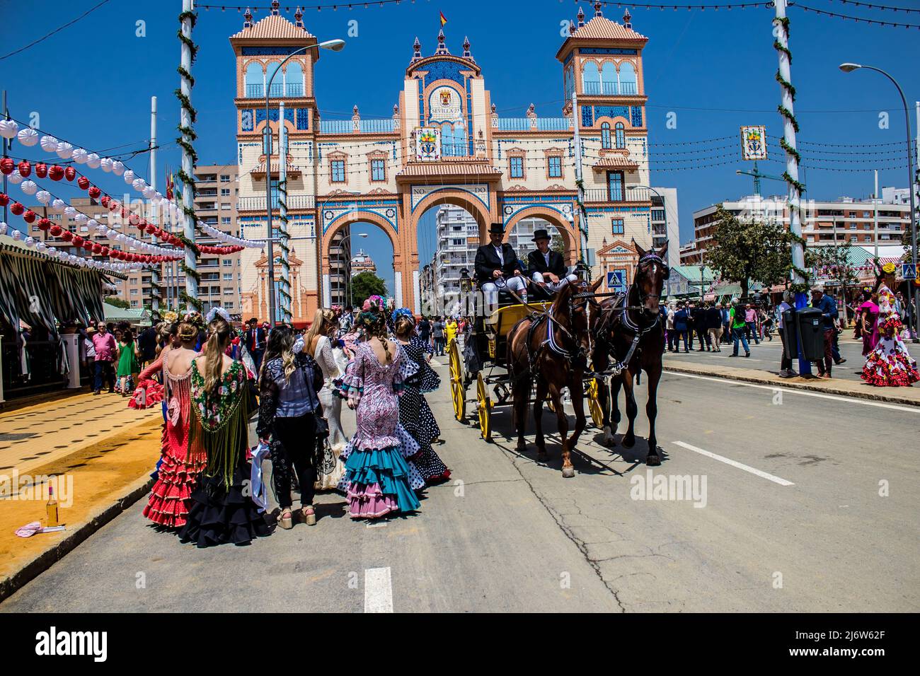 Seville, Spain - May 01, 2022 Sevillians dressed in traditional ...
