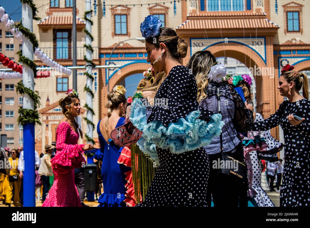 Seville, Spain - May 01, 2022 Sevillians dressed in traditional ...