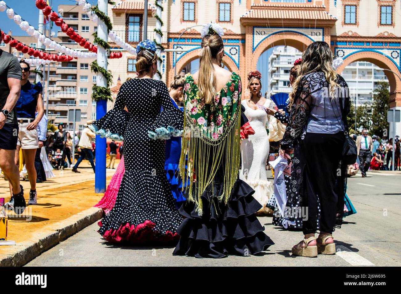 Seville, Spain - May 01, 2022 Sevillians dressed in traditional ...