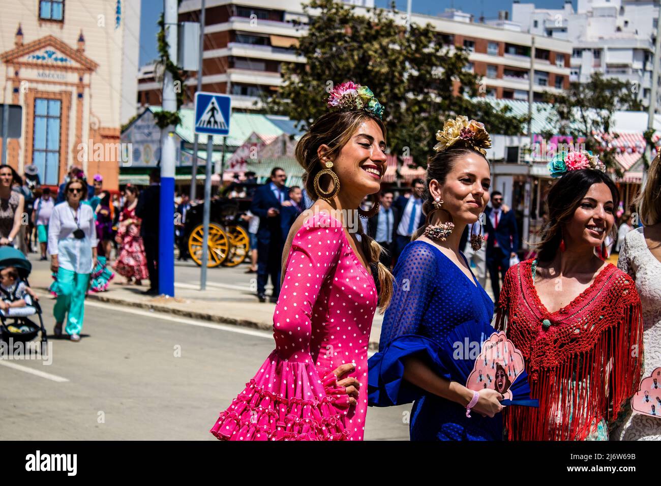 Seville, Spain - May 01, 2022 Sevillians dressed in traditional ...
