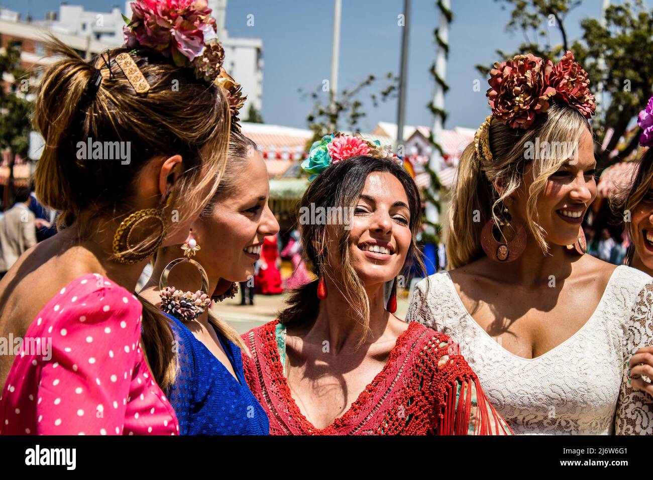 Seville, Spain - May 01, 2022 Sevillians dressed in traditional ...